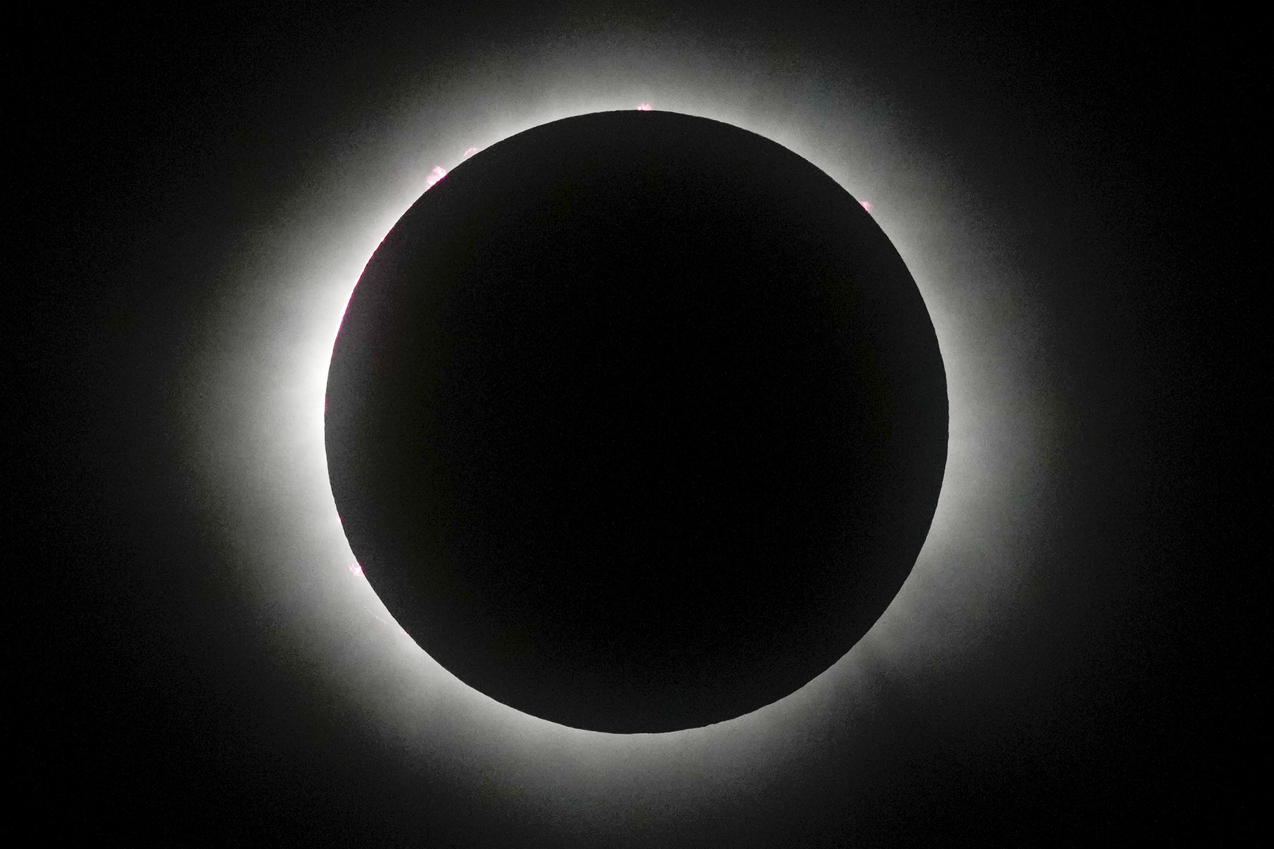 A total solar eclipse races across North America as clouds part along ...